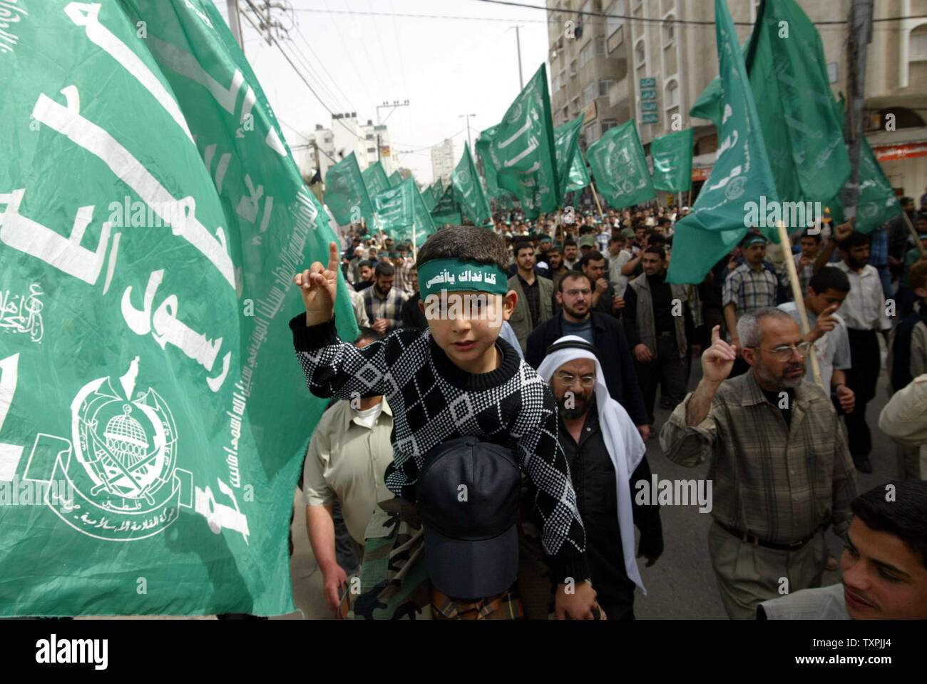 Thousands of supporters of Hamas walk in Gaza City's main Al-Jalaa ...