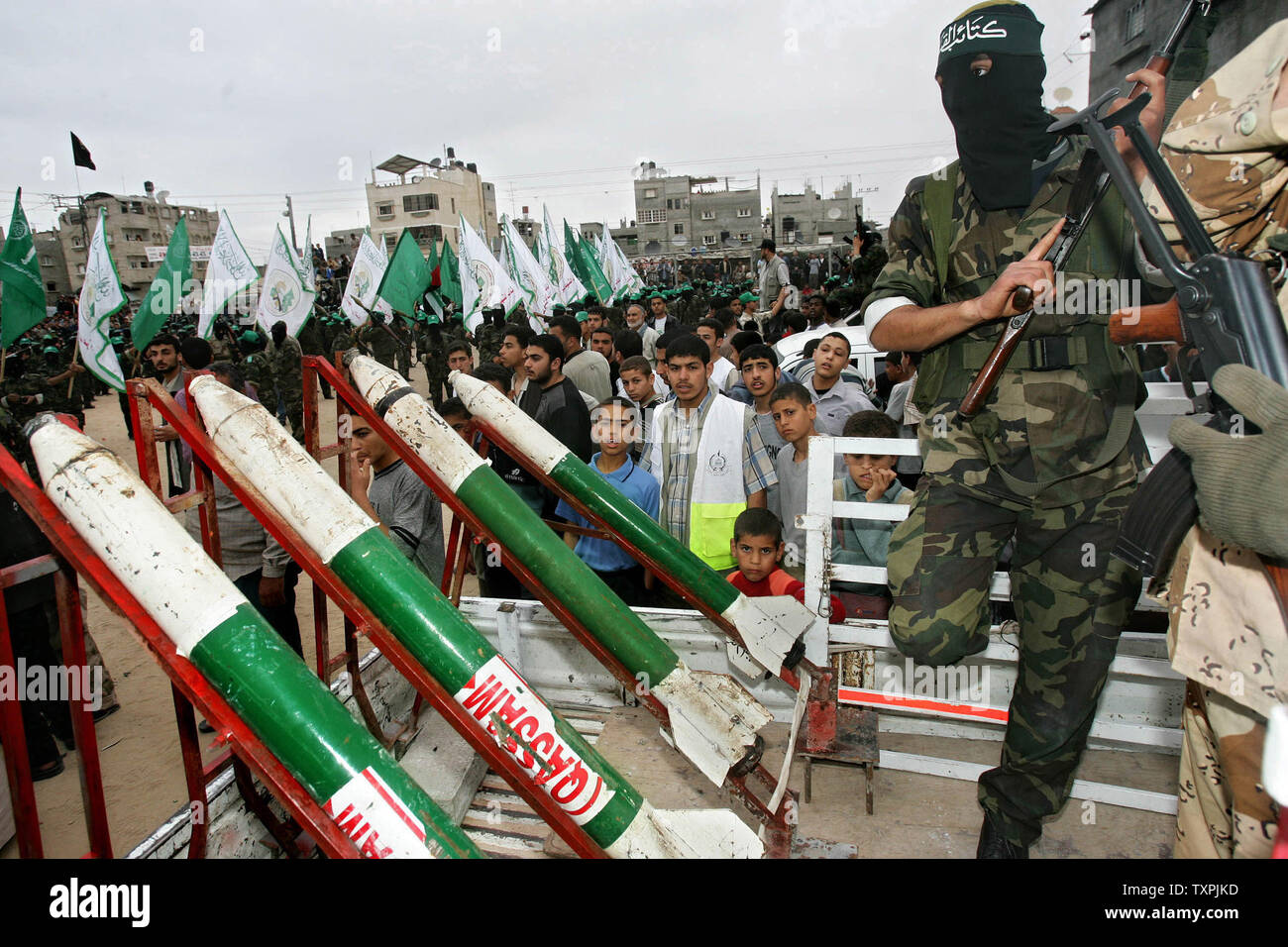 Members of Hamas show what appear to be homemade Qassam rockets that can be shot towards an ...