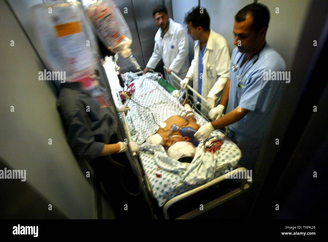 Palestinian medical workers aid one of four Palestinian members of the ...