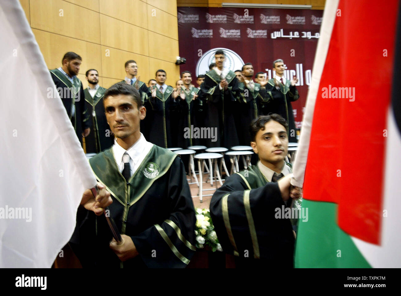 Palestinian students carry the Palestinian flag during the graduation ...
