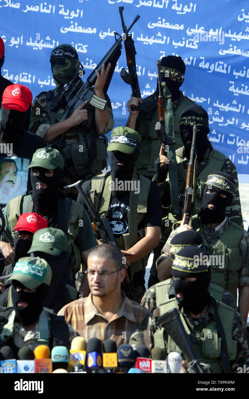 Members of eight armed Palestinian factions stand during a joint press ...