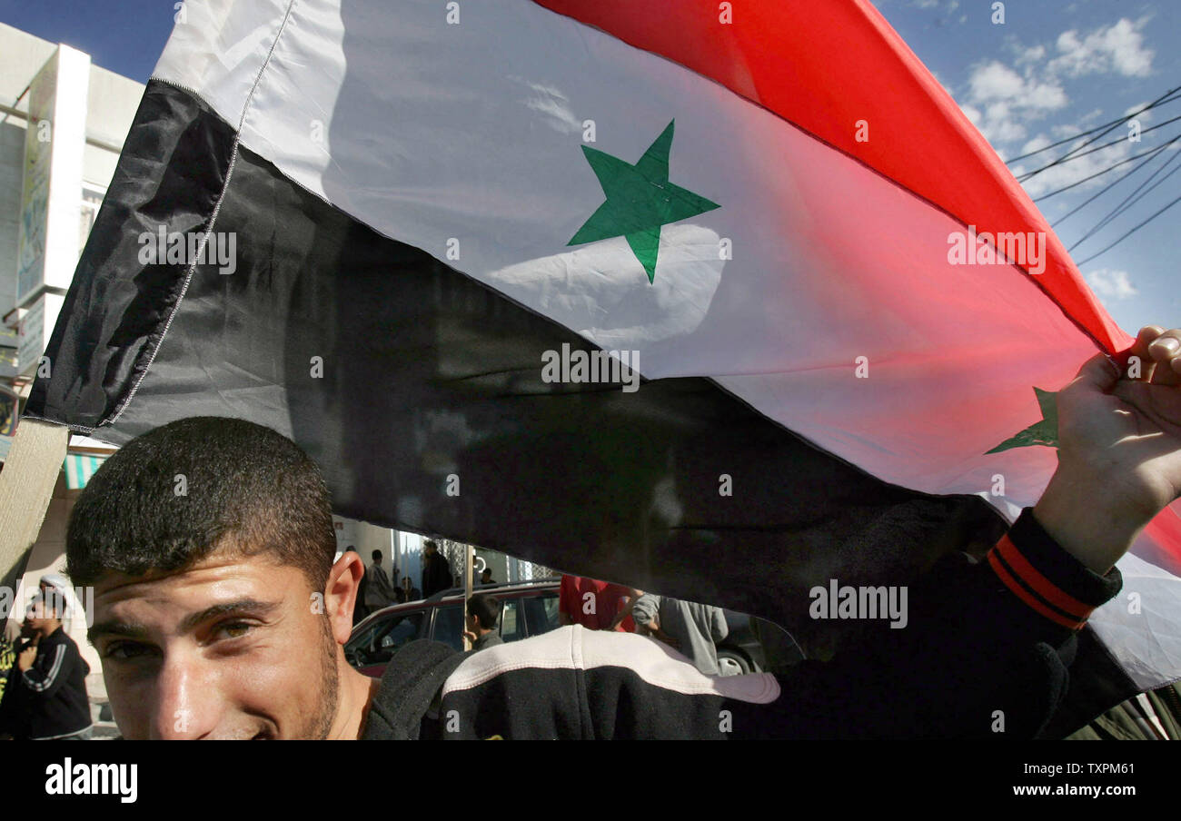A Palestiniain supporter of the Islamic Jihad hold Syrian flag, during ...