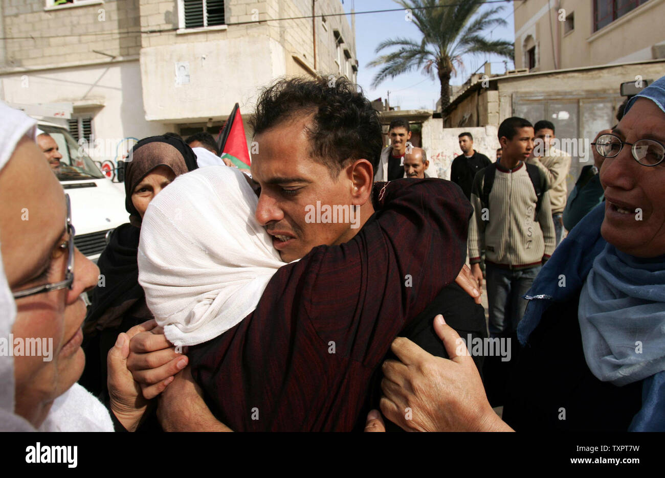 Freed Palestinian prisoner Tayser Subhi Baraka (C) age 25, hugs his ...