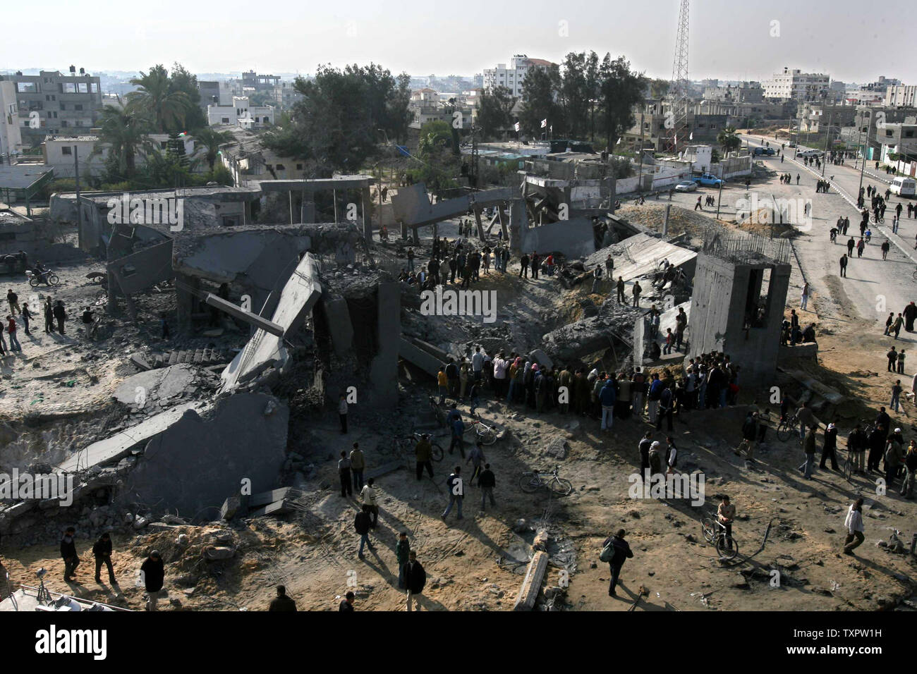 Palestinians gather at the site of an Israeli air strike on Badr Mosque ...