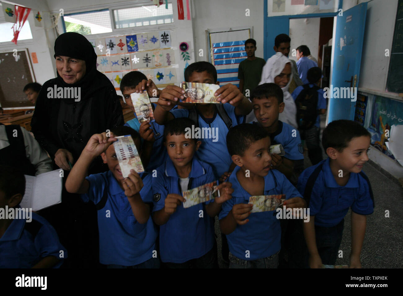 Palestinian primary school students display the one hundred New Israeli ...