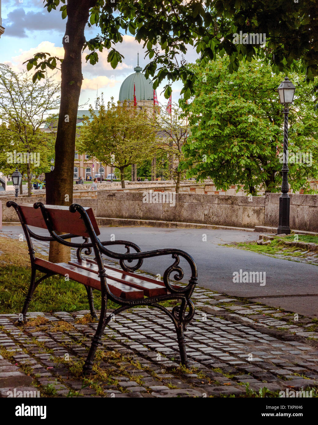 A bench in the Budapest Castle District with the dome of the Royal ...