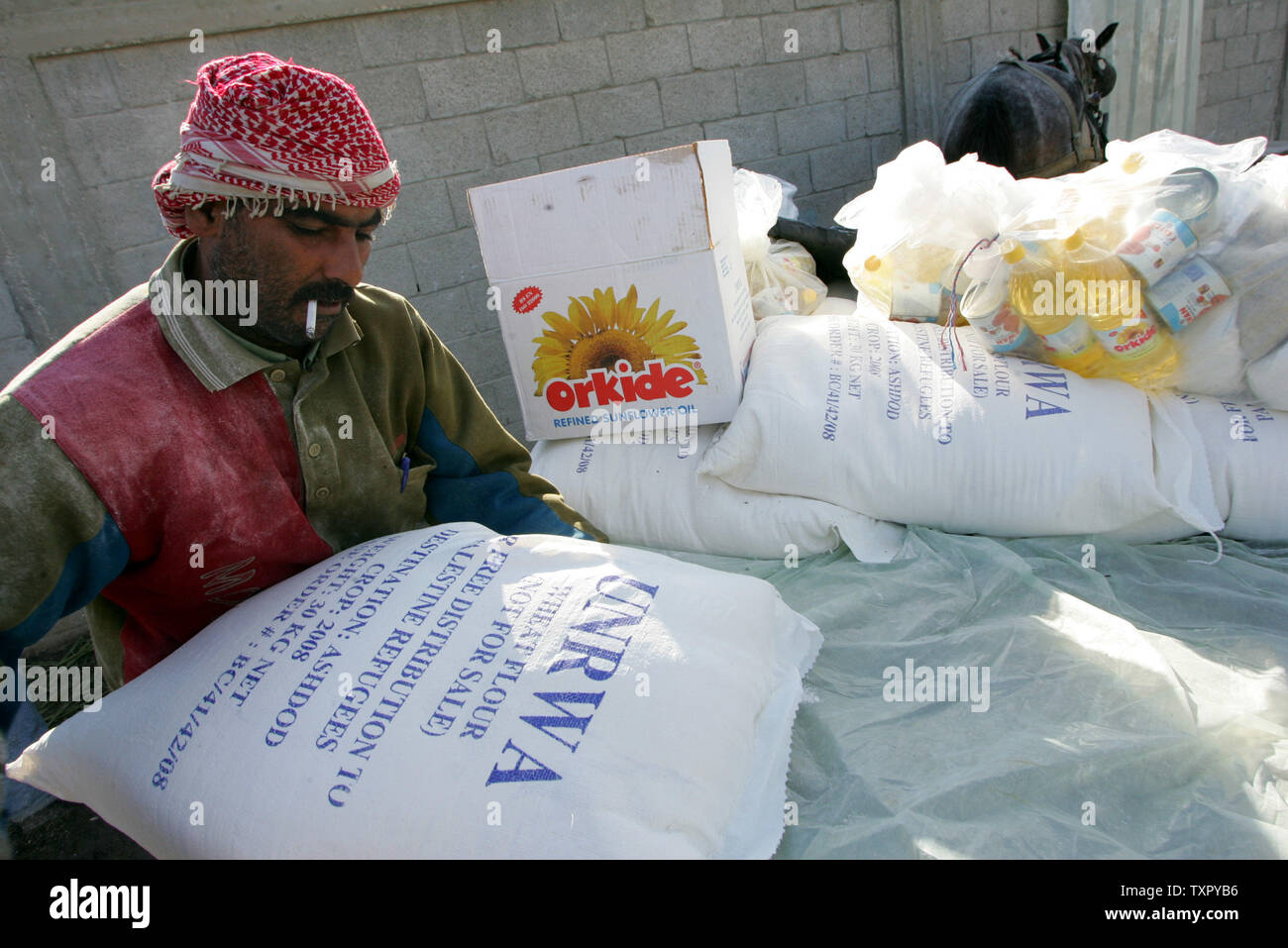 Palestinian carries sacks of flour hi-res stock photography and images ...