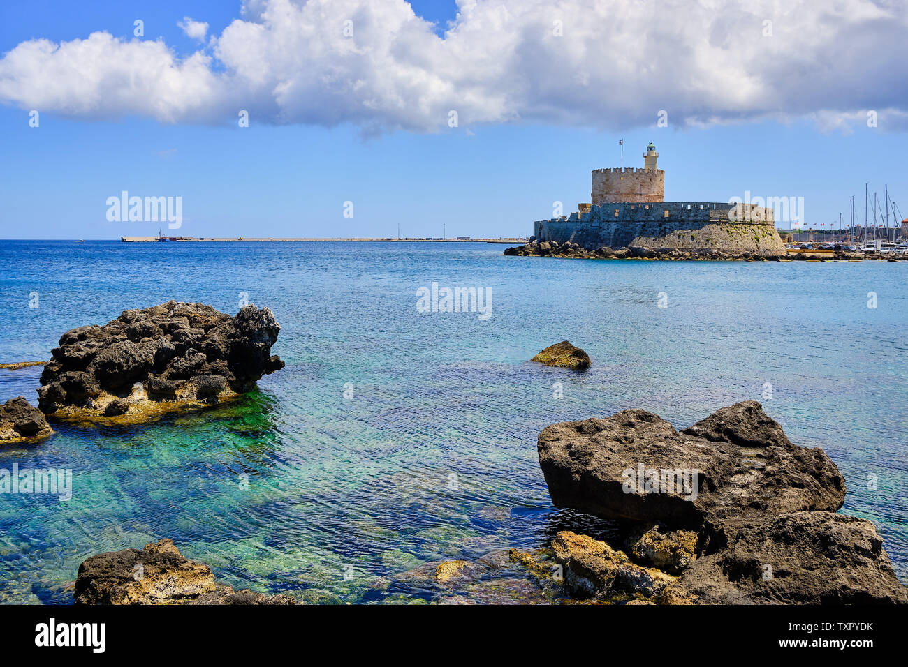 a medieval castle by the sea with cliffs in the foreground Stock Photo ...