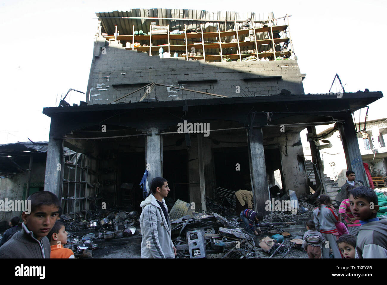 Palestinians inspect the rubble at the al-Abrar mosque after overnight ...