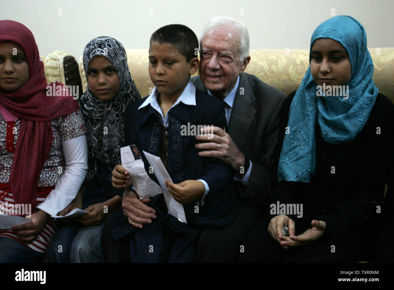 Former U.S. President Jimmy Carter (2nd R) poses for a photo with ...