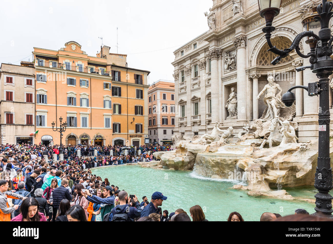 ROME, ITALY - APRIL 22, 2019: Crowd of tourists visiting the Trevi ...