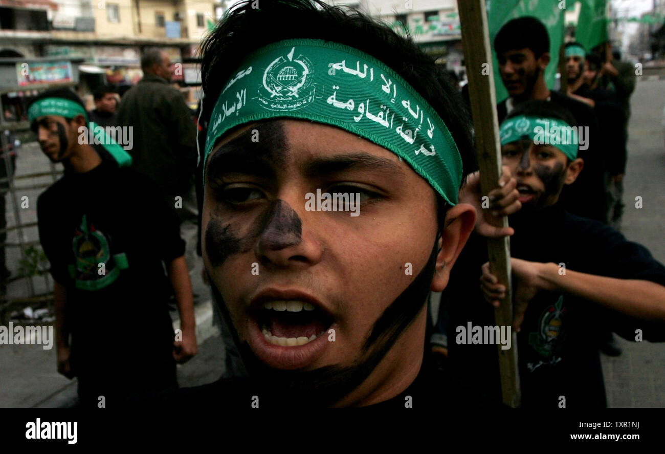Palestinian members of Hamas attend a rally ahead of the movement's ...
