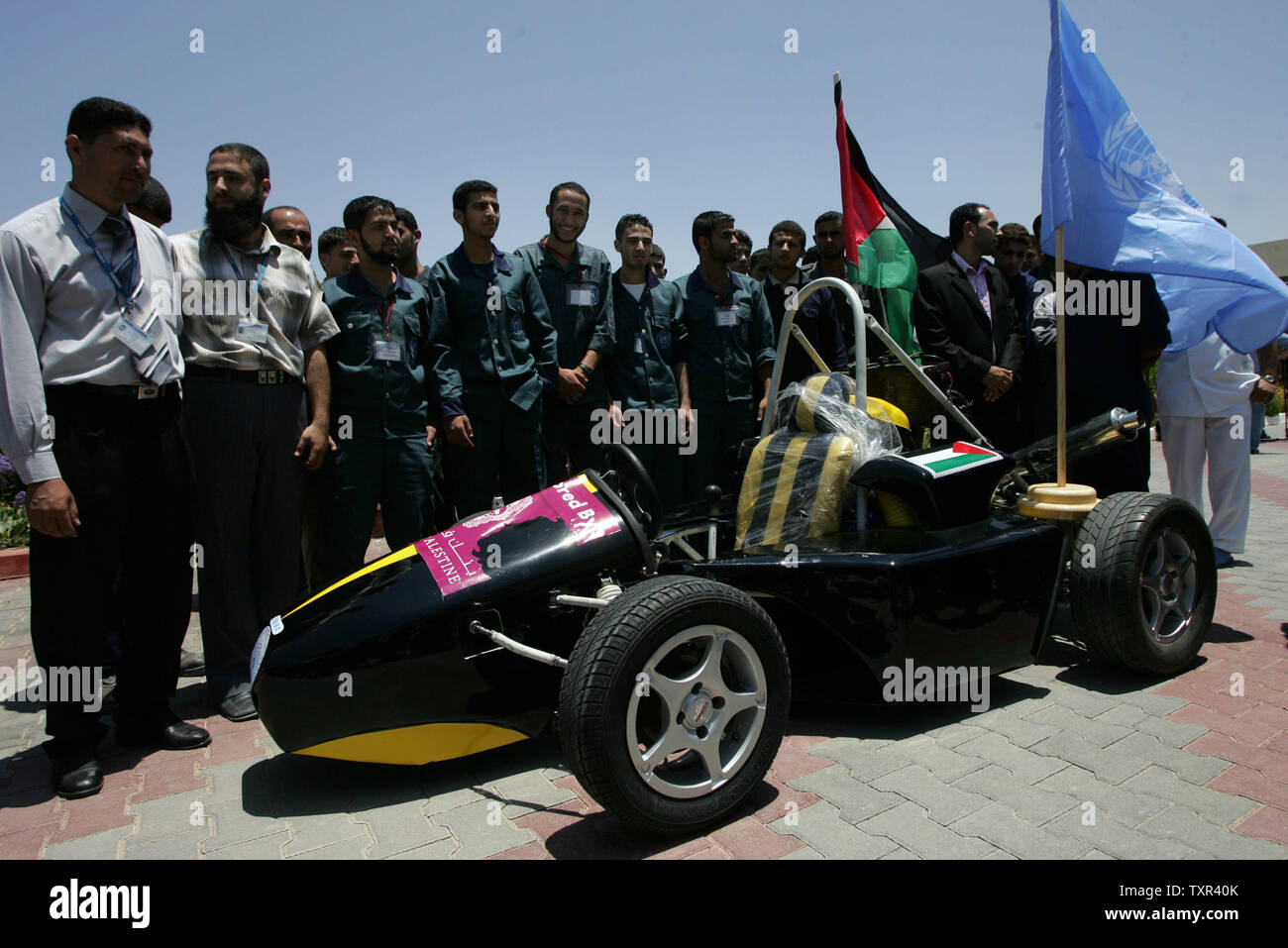 Palestinian students pose next to their Formula 1-style racing car ...