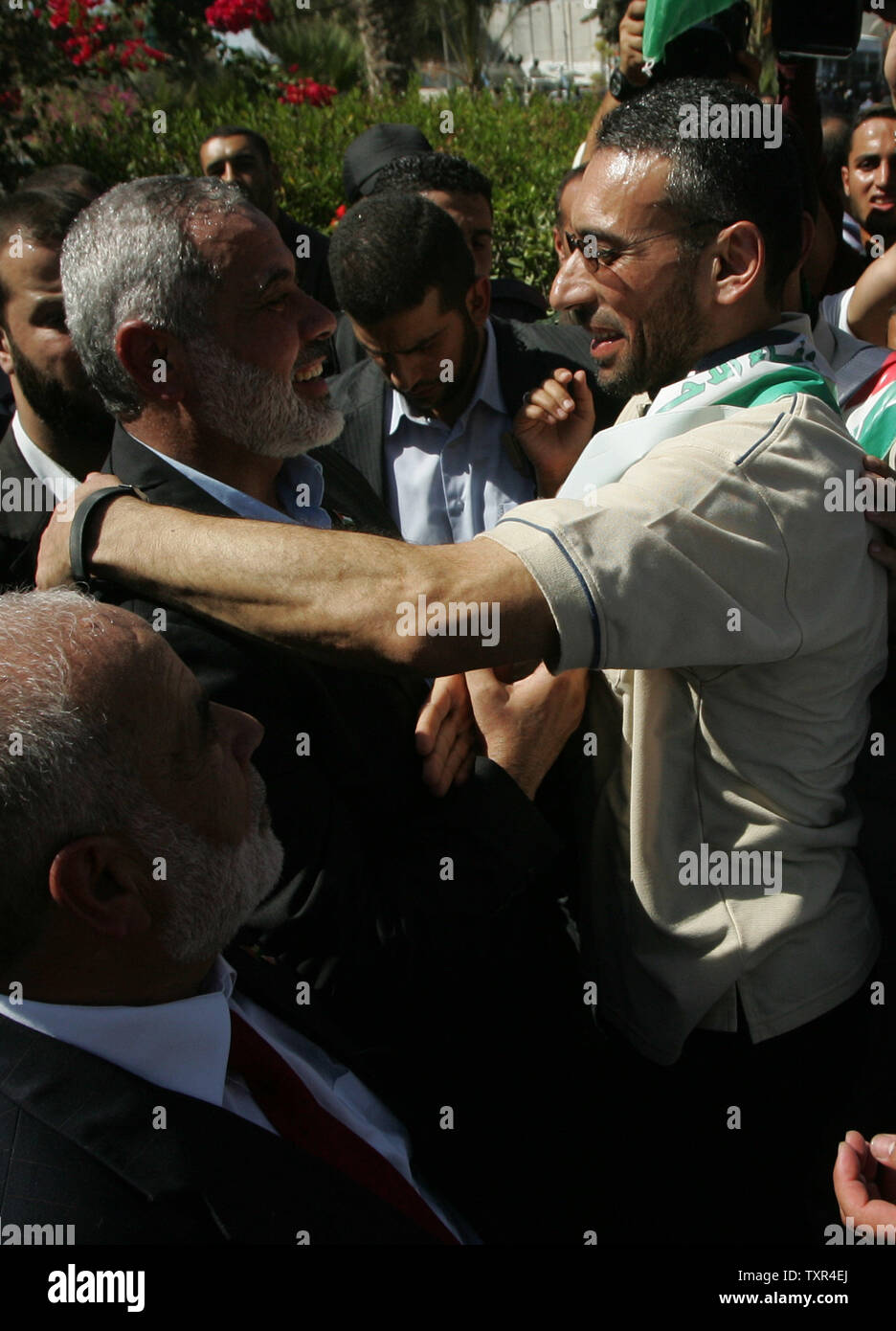 A freed Palestinian prisoner (R) is greeted by senior Hamas leader ...