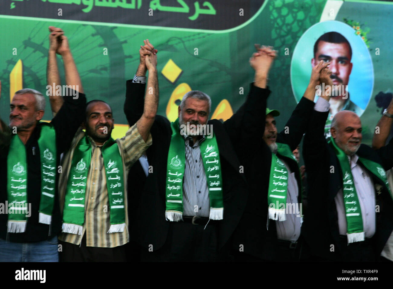 Hamas leader Ismail Haniyah (c) attends a ceremony celebrating the ...