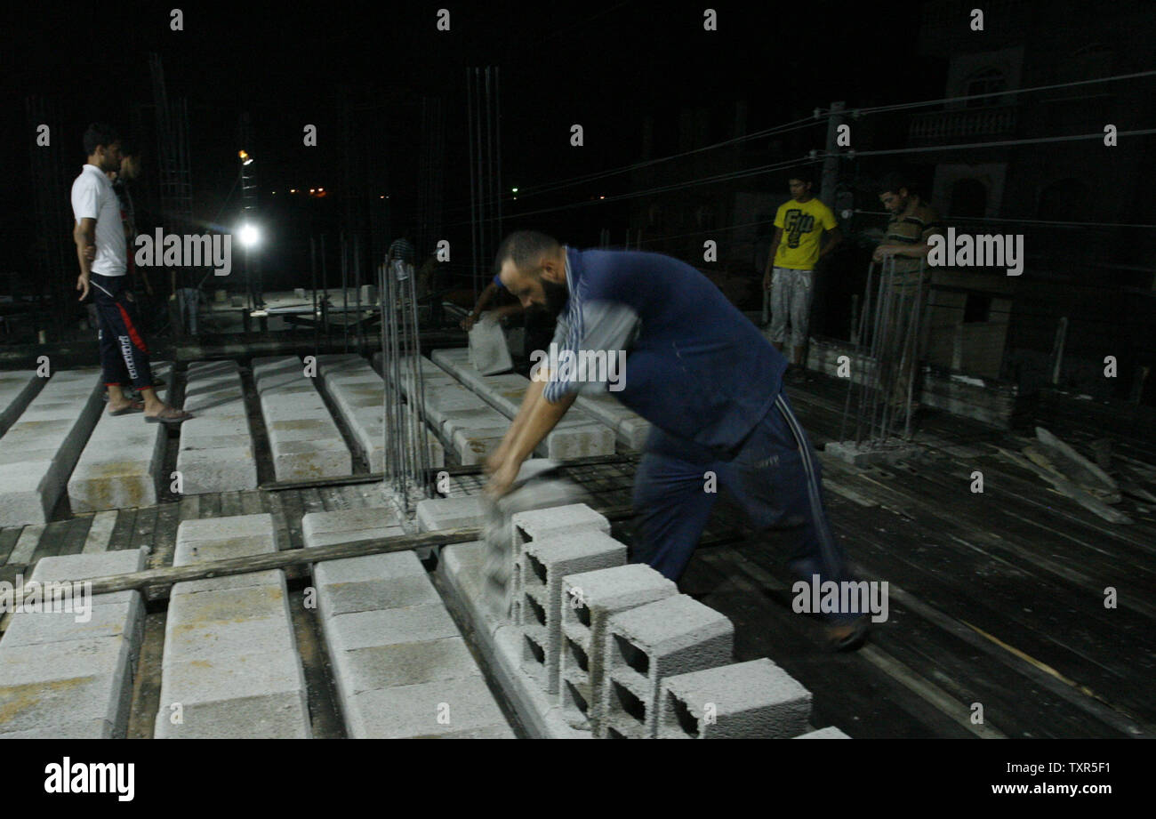 Palestinian Construction workers work at night in Rafah in southern ...