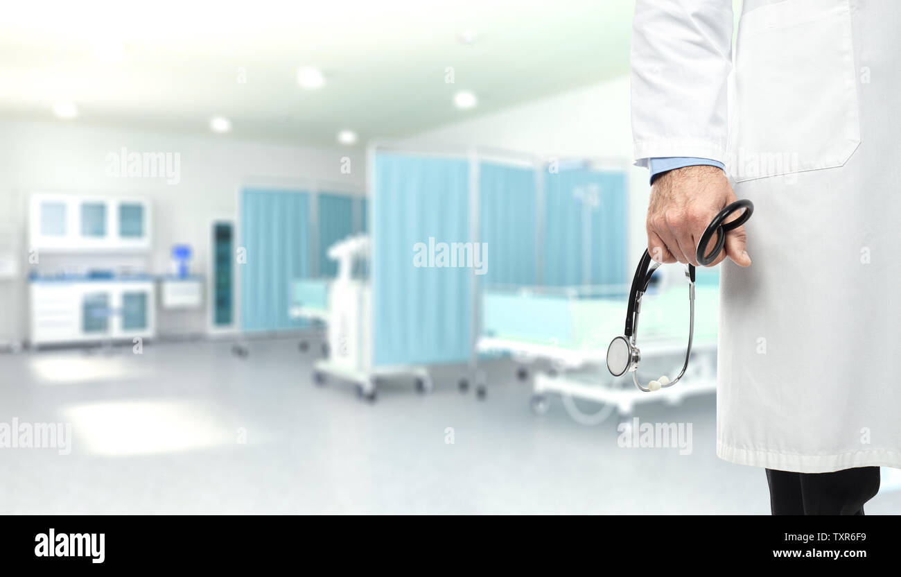 detail of a doctor holding a stethoscope inside a hospital. Concept of ...