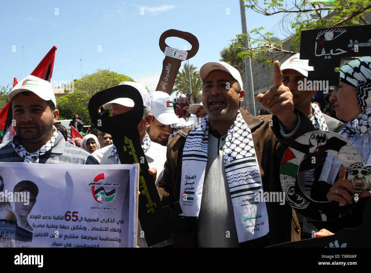 A Palestinian man holds replicas of house keys, representing the front ...