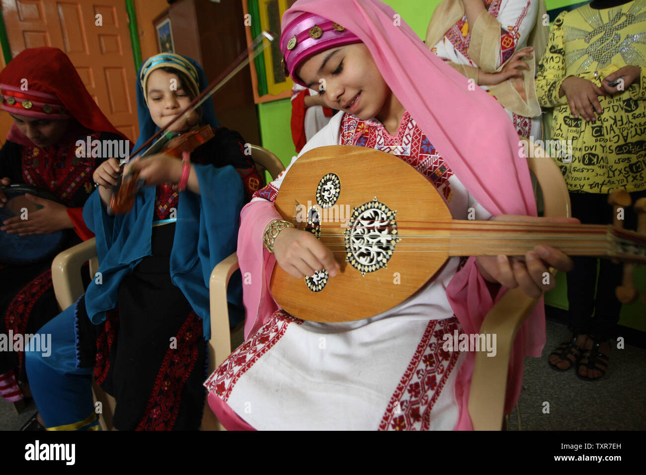 Palestinian children attend a music class at the Gaza Music School ...