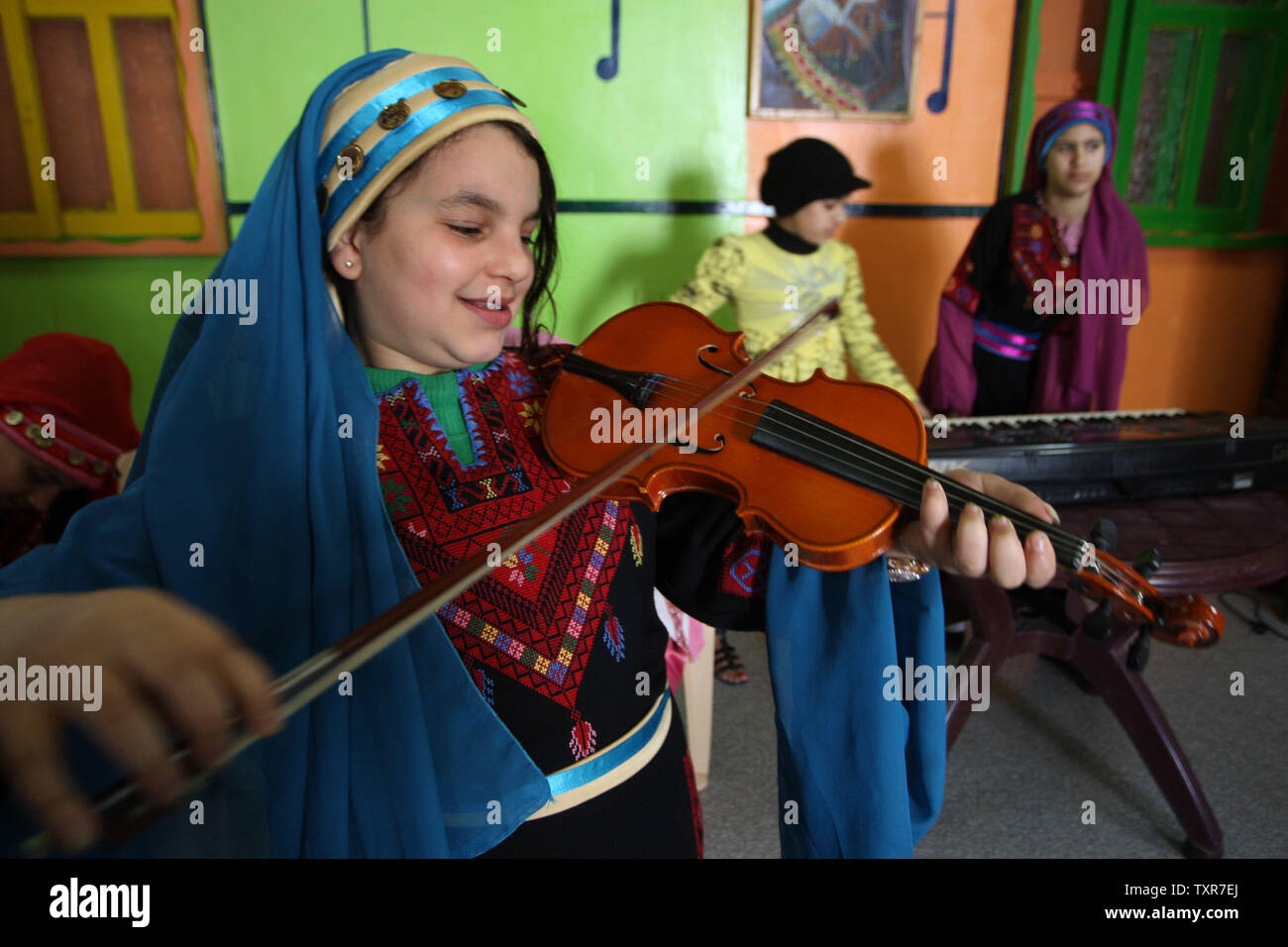Palestinian children attend a music class at the Gaza Music School ...