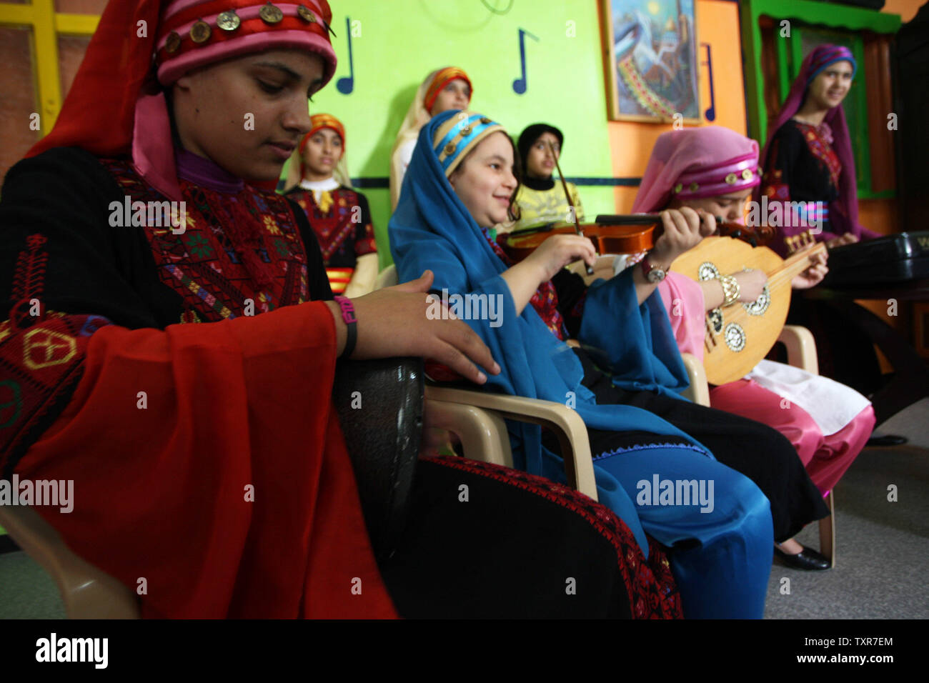 Palestinian children attend a music class at the Gaza Music School ...