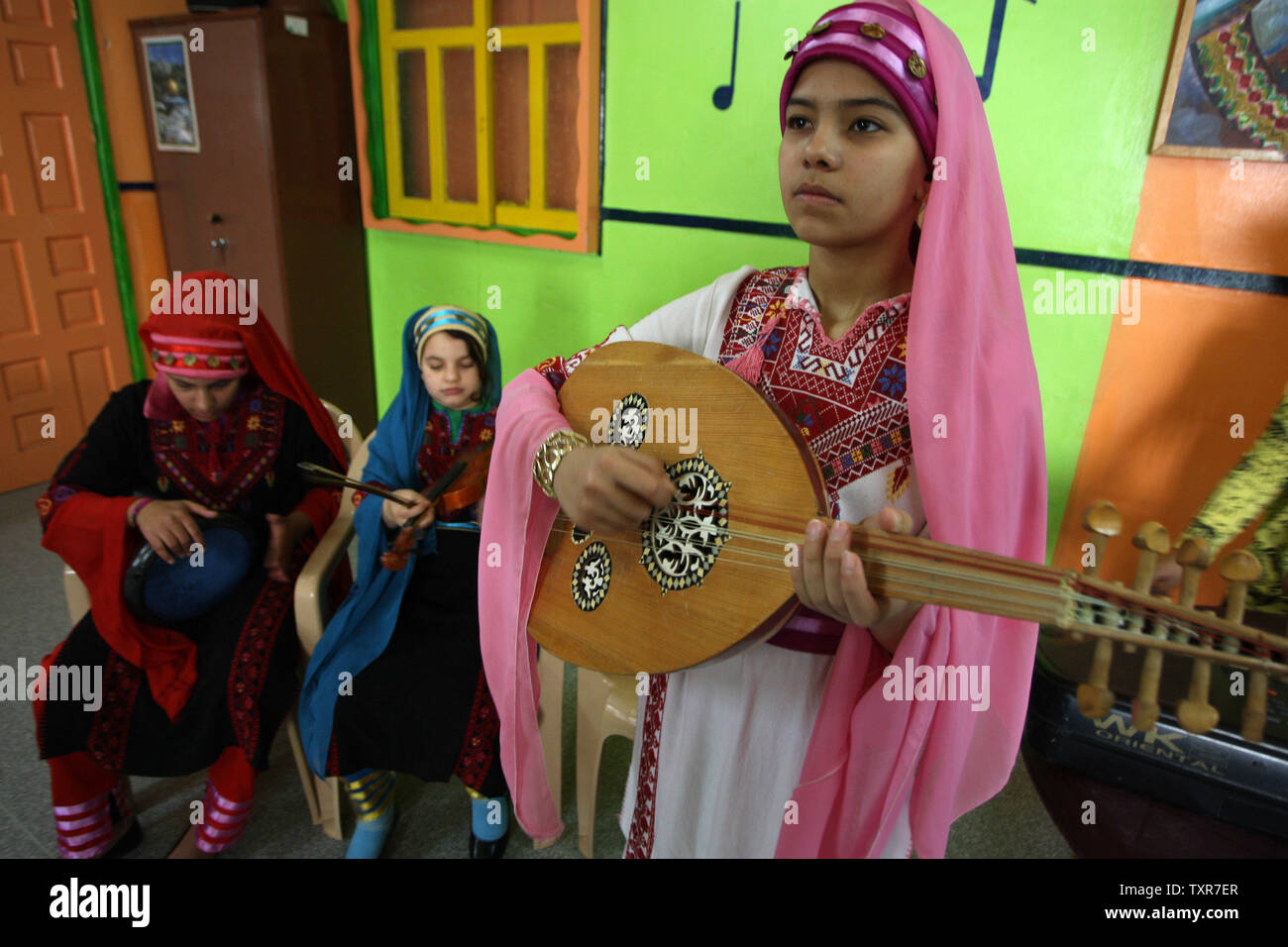 Palestinian children attend a music class at the Gaza Music School ...