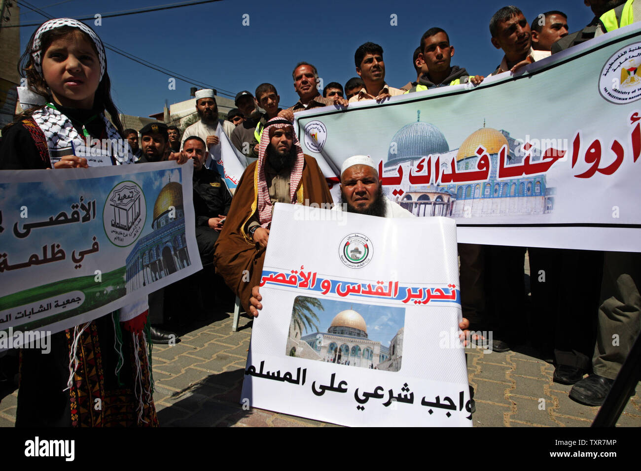 Palestinians carry the pictures of al-Aqsa mosque during a protest ...