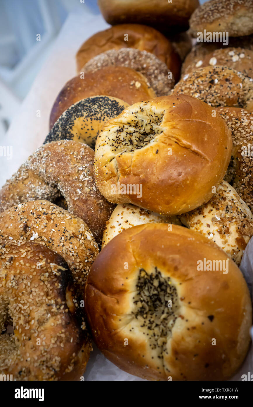 A selection of bagels, rolls and other bread products on display at a ...