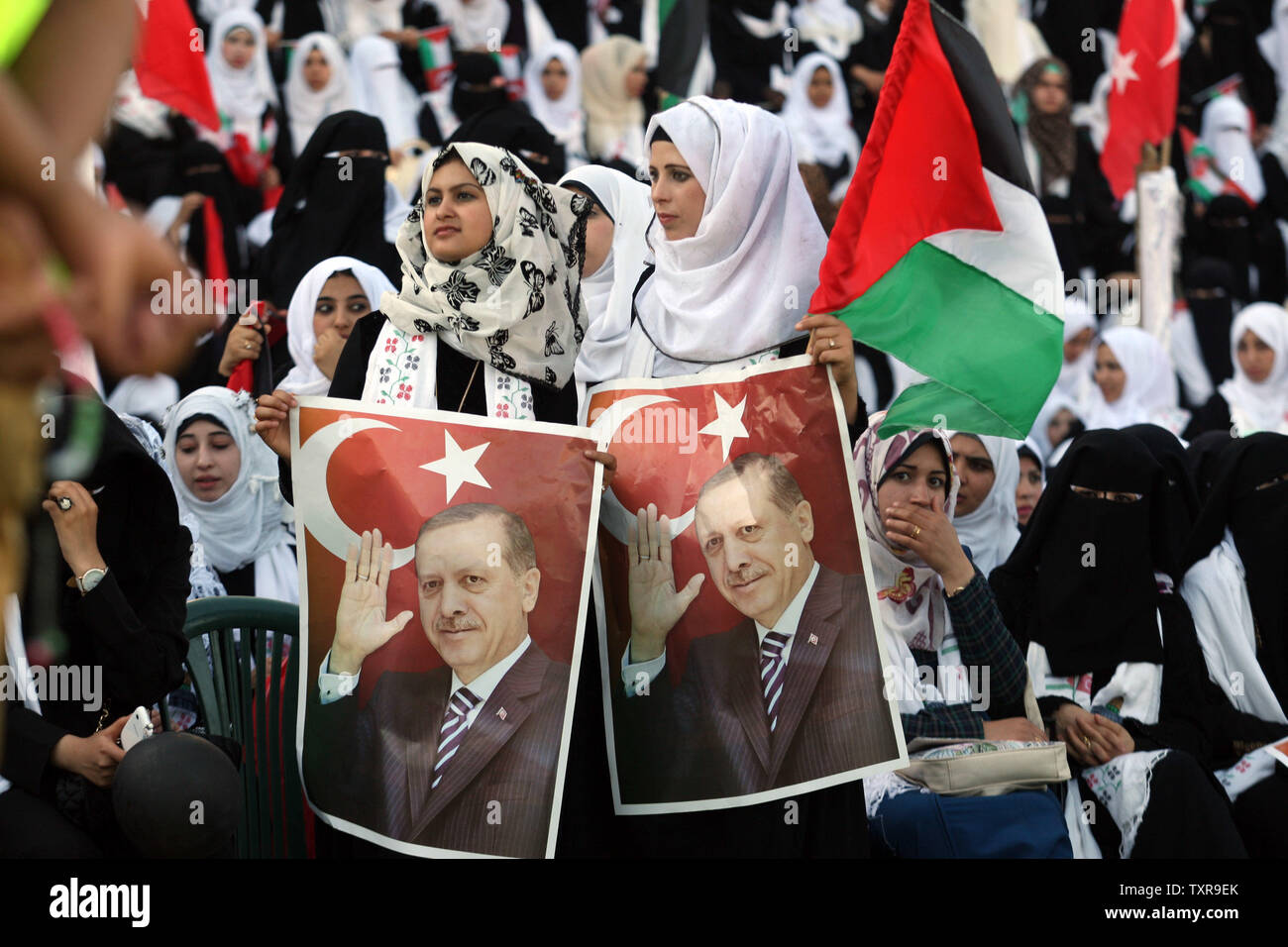 Palestinian brides hold posters bearing the portrait of Turkish ...