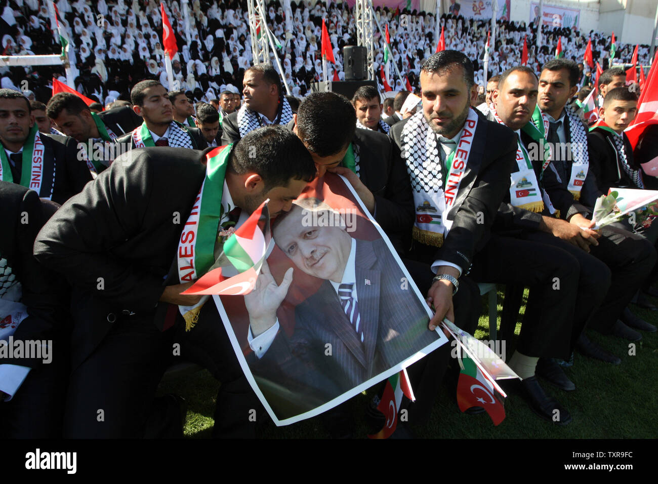 Palestinian grooms kiss posters bearing the portrait of Turkish ...