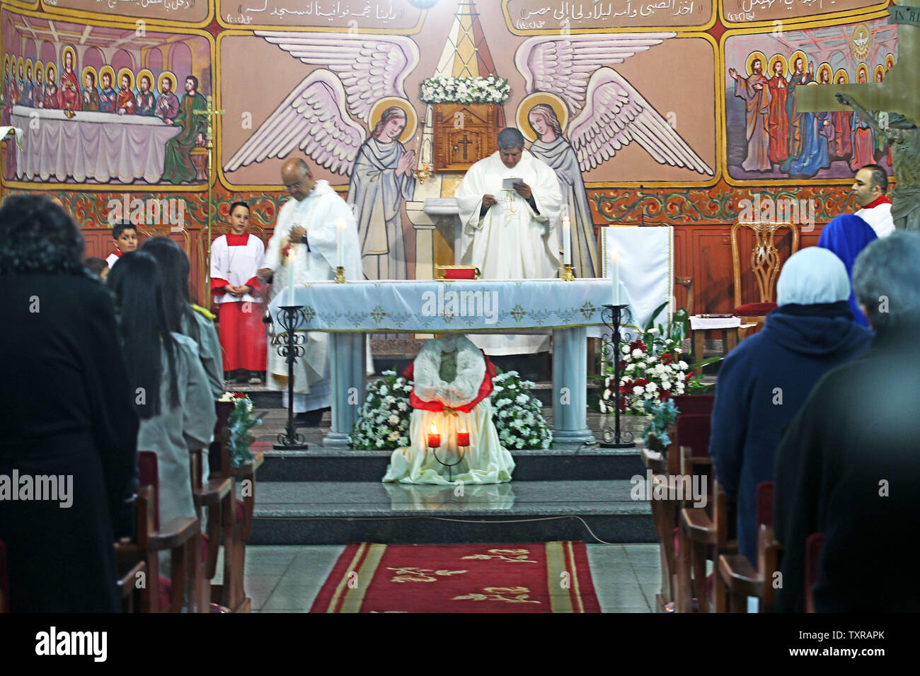 Christian clerics lead a Christmas mass at the Holy Family Church, in ...