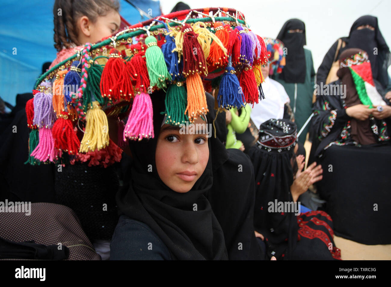 A Palestinian girl is seen dressed in traditional costume during a tent ...
