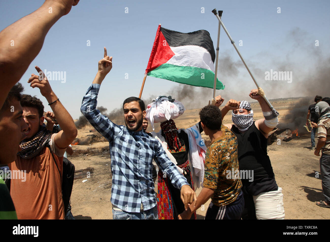 Palestinians shout slogans during a protest marking al-Quds Day ...
