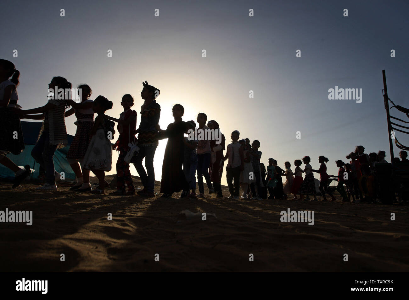 Palestinians celebrate on the third day of Eid al-Fitr holiday which ...
