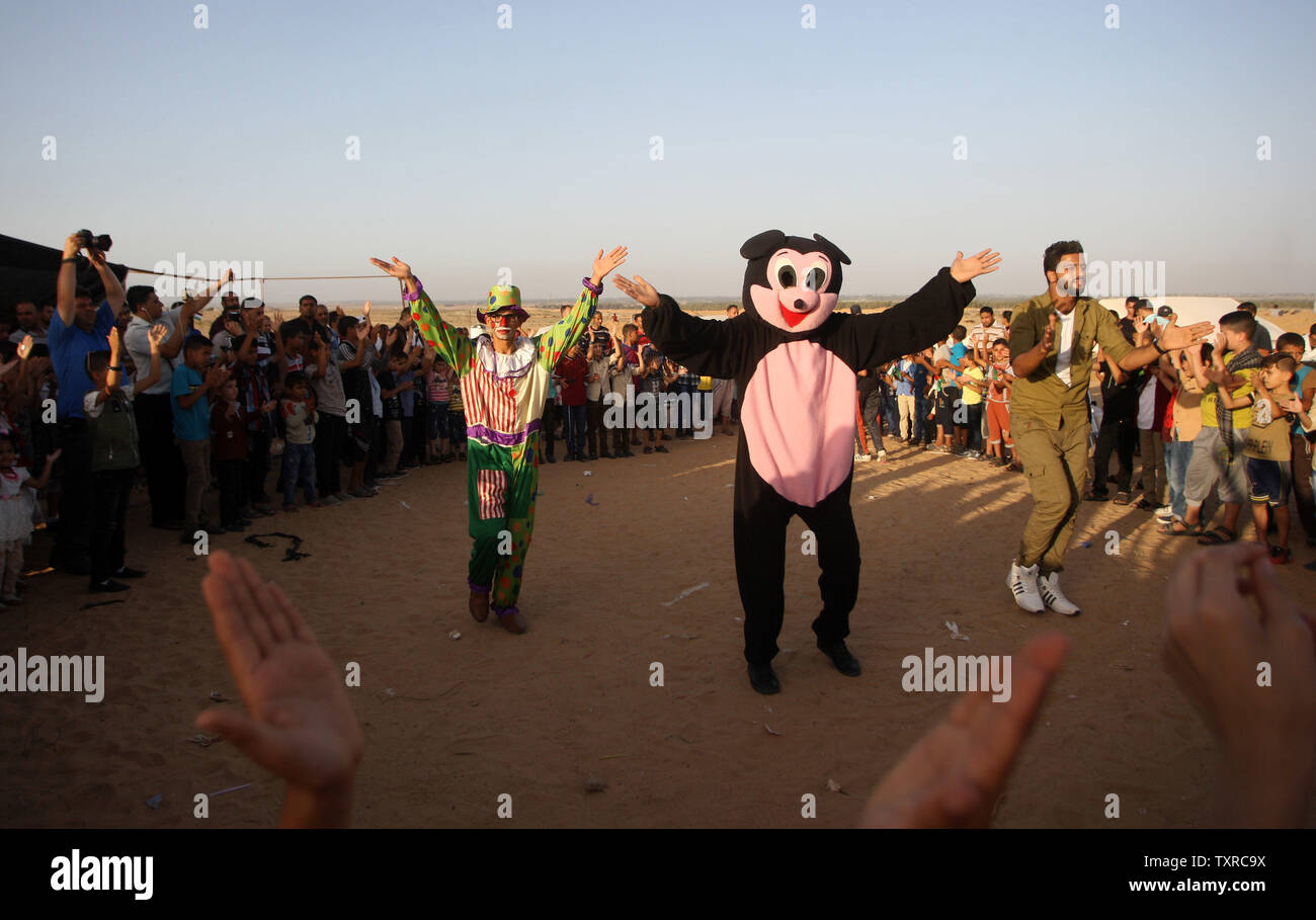 Palestinians celebrate on the third day of Eid al-Fitr holiday which ...
