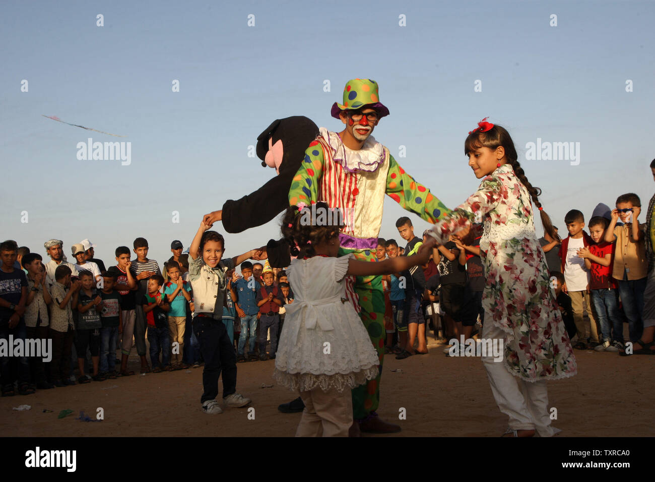 Palestinians celebrate on the third day of Eid al-Fitr holiday which ...