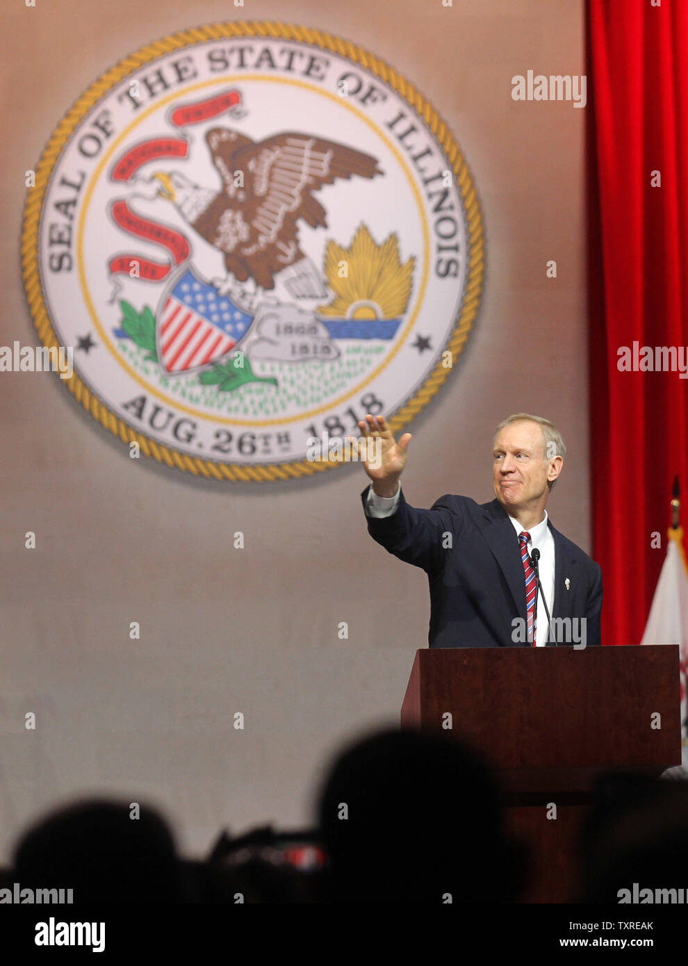 Illinois Governor Bruce Rauner waves to the crowd during ceremonies at ...