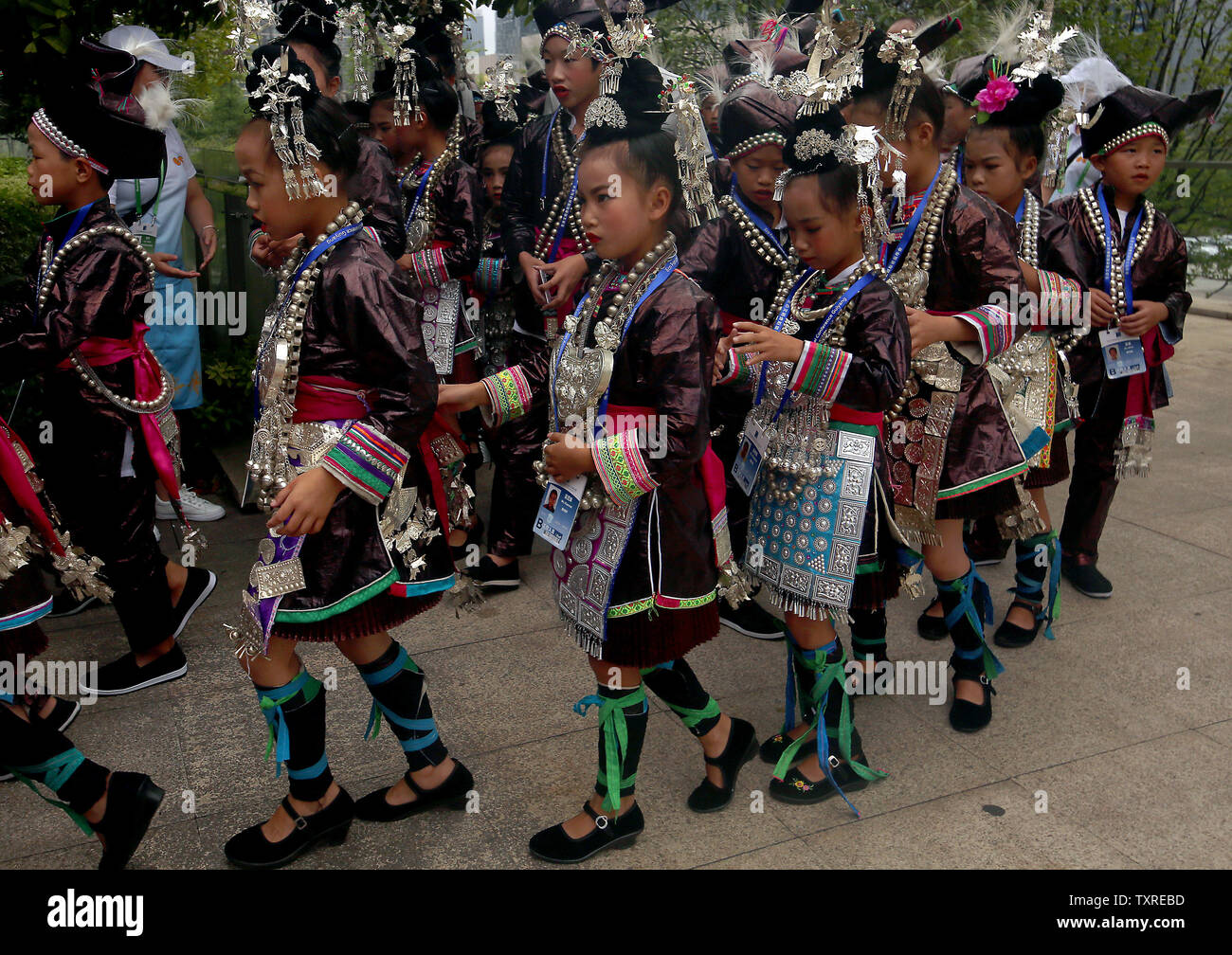 Dong children dressed in traditional clothing prepare to sing at a ...