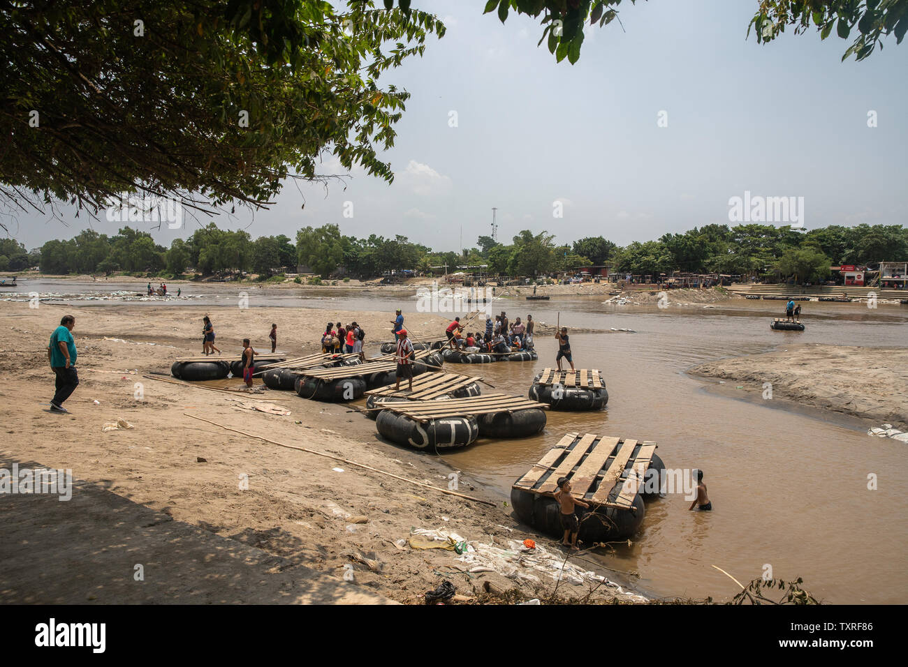 Rafts made out of inflatable tires ferry people across the Suchiate ...
