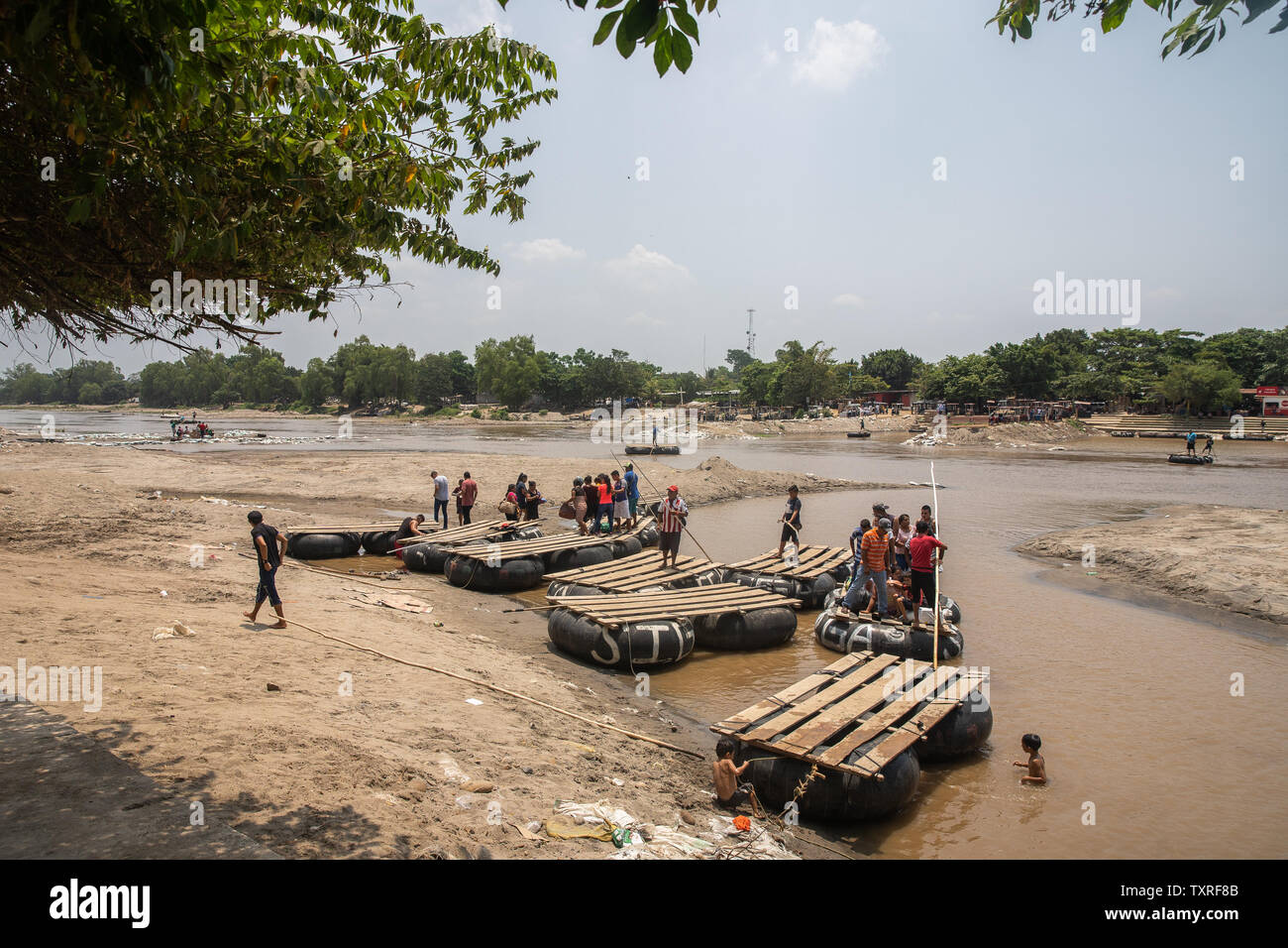 Rafts made out of inflatable tires ferry people across the Suchiate ...