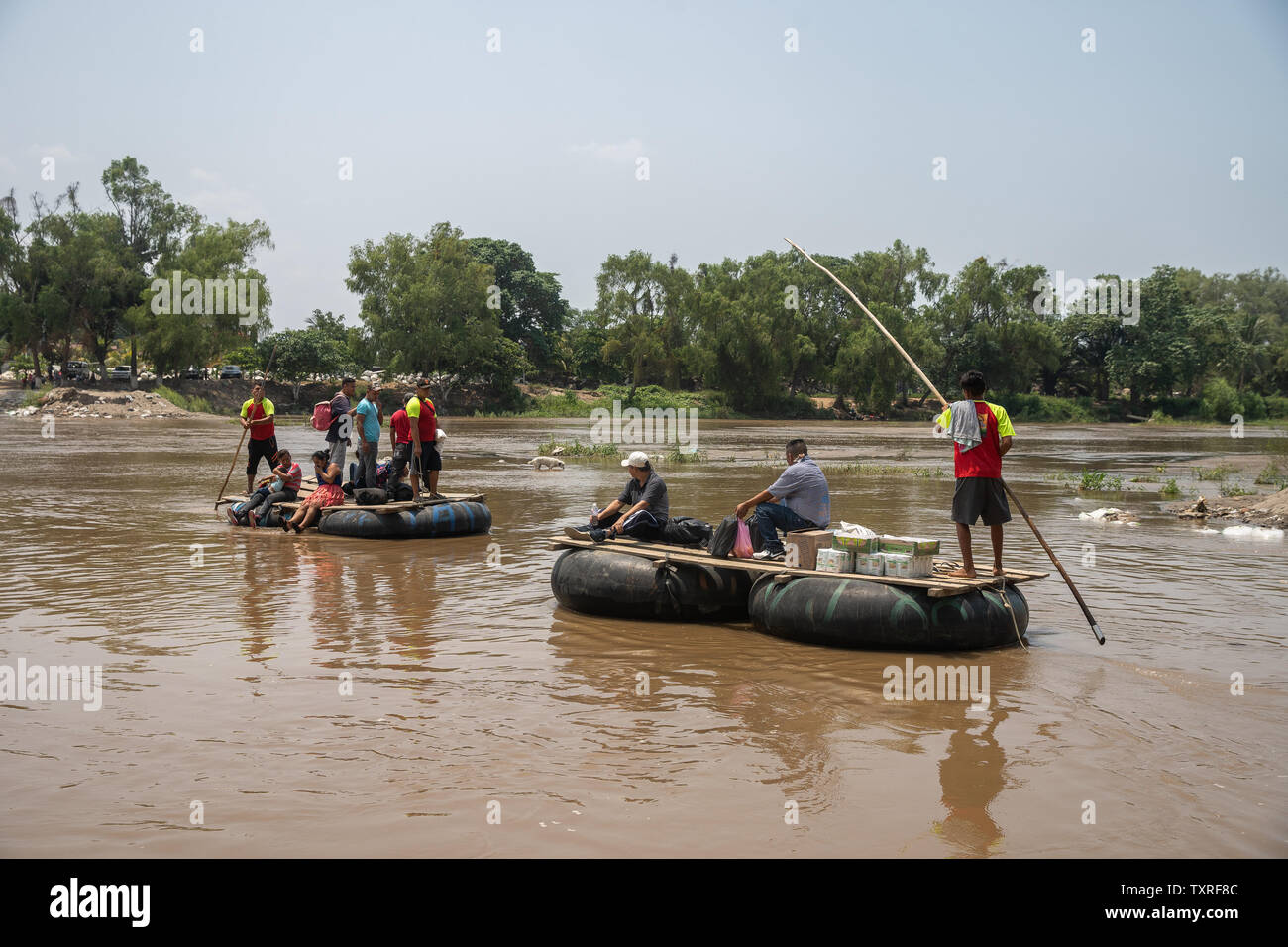 Rafts made out of inflatable tires ferry people and goods across the ...