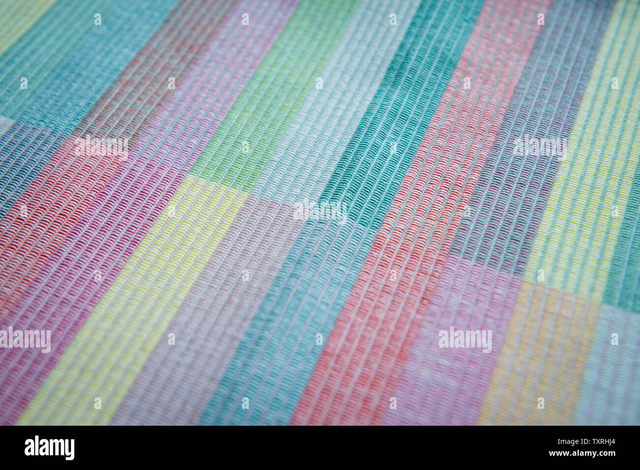 Colorful textile abstract background in a full frame close-up of angled ...