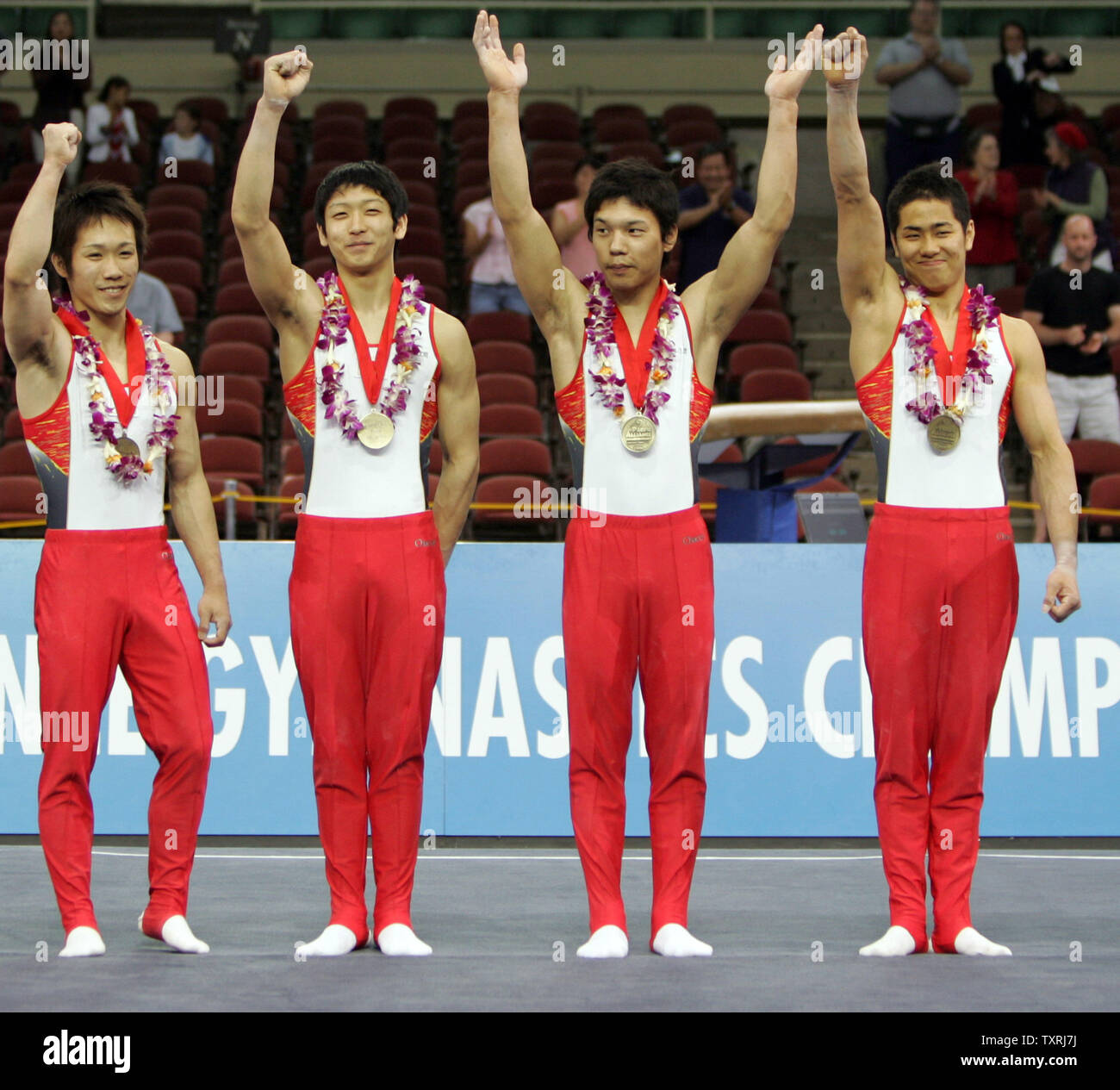 The Japanese gymnastics team celebrates victory in the men's team ...