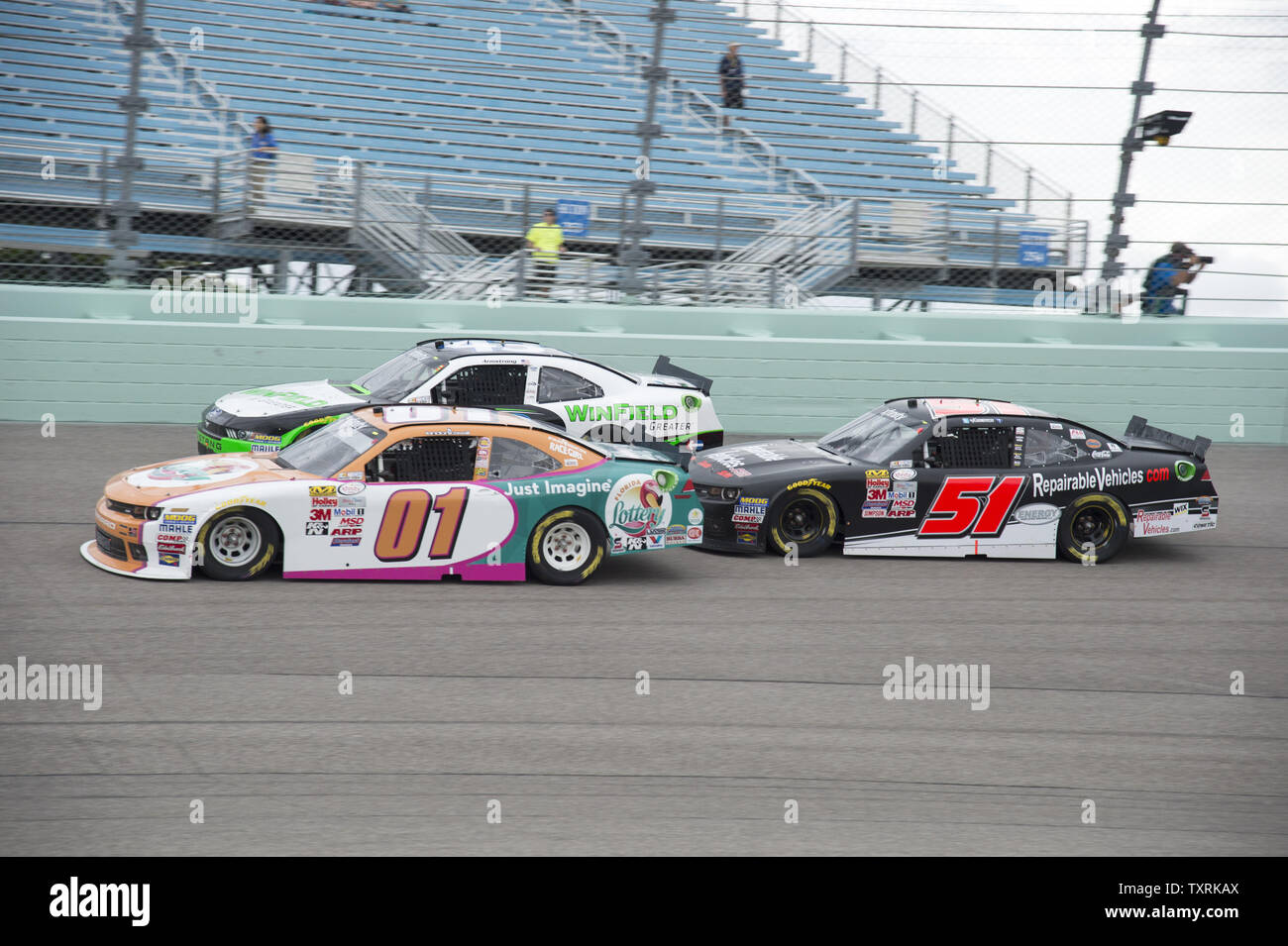 Driver Harrison Rhodes in Car #01 leads a pack of other racers at the ...