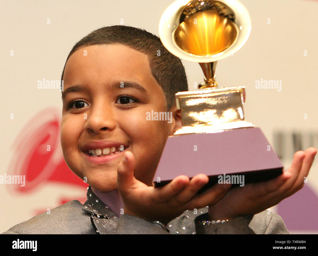 Singer Miguelito shows off his best latin children's album award in the ...