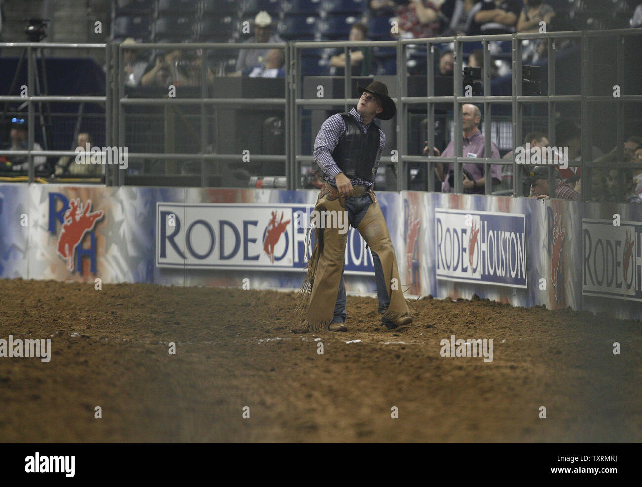 Scott Miller looks at the scoreboard to see his score after riding a ...