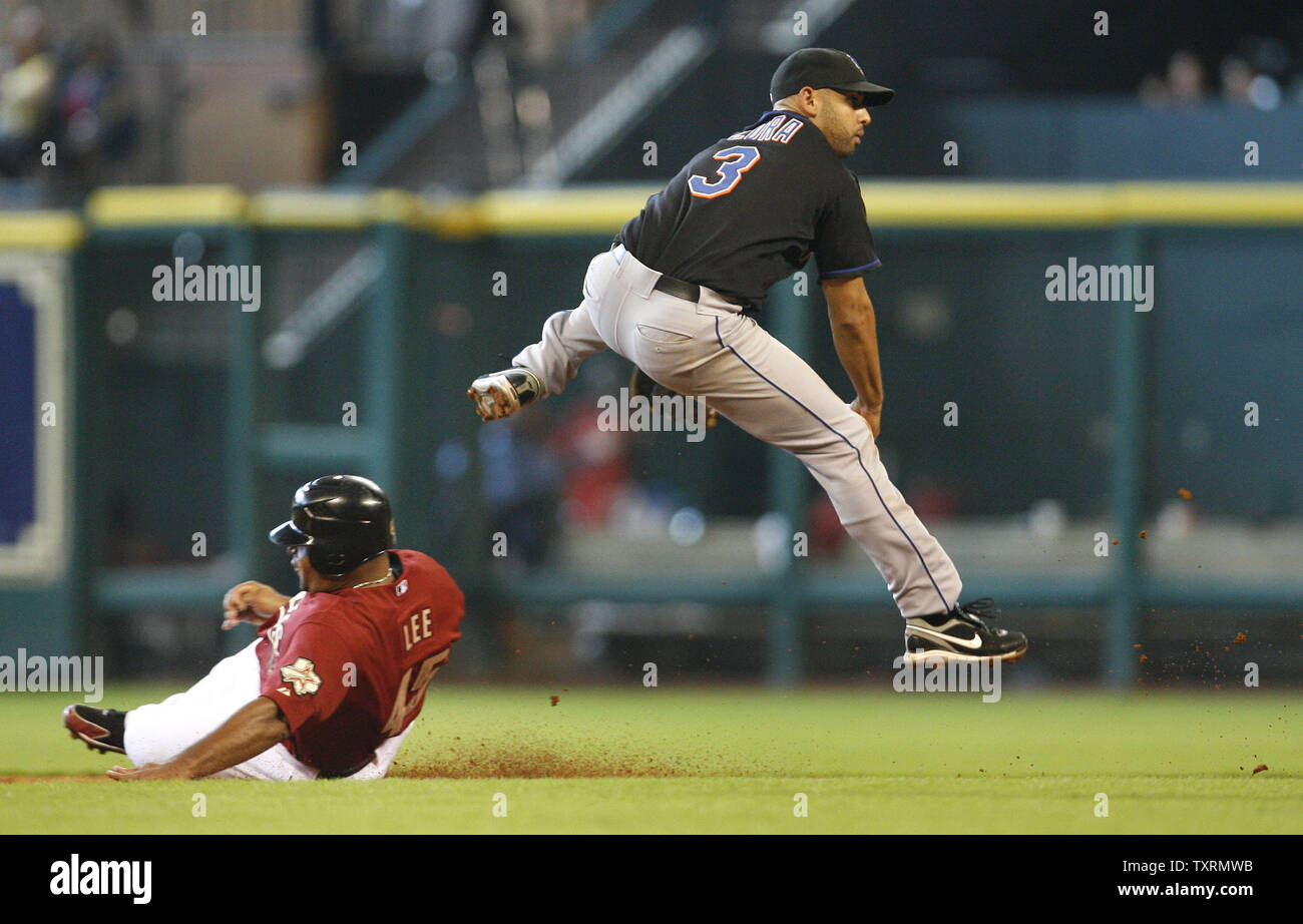 New York Mets shortstop Alex Cora (R) leaps over Houston Astros left ...