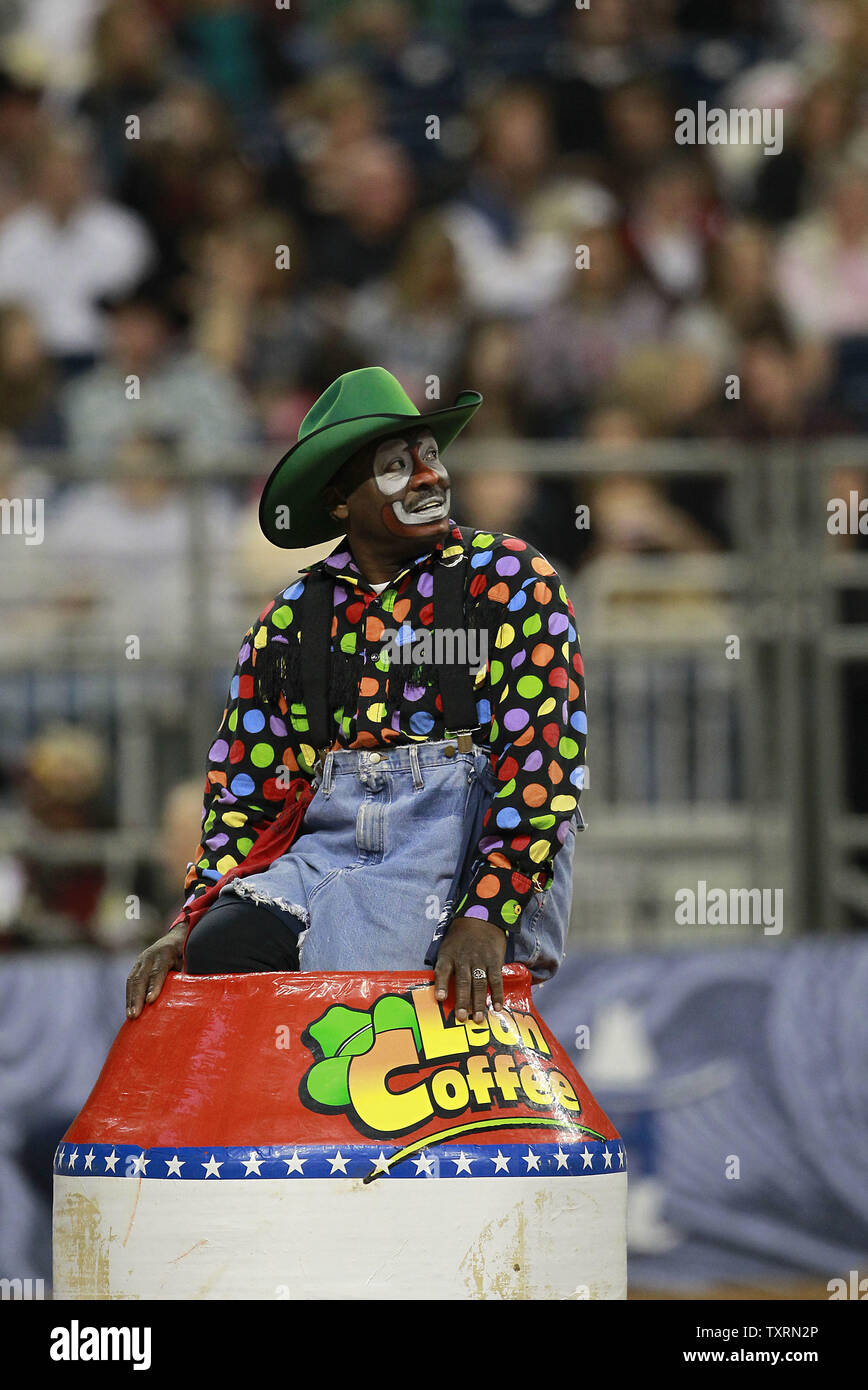 Rodeo clown Leon Coffee glances at the replay monitor during the bull ...