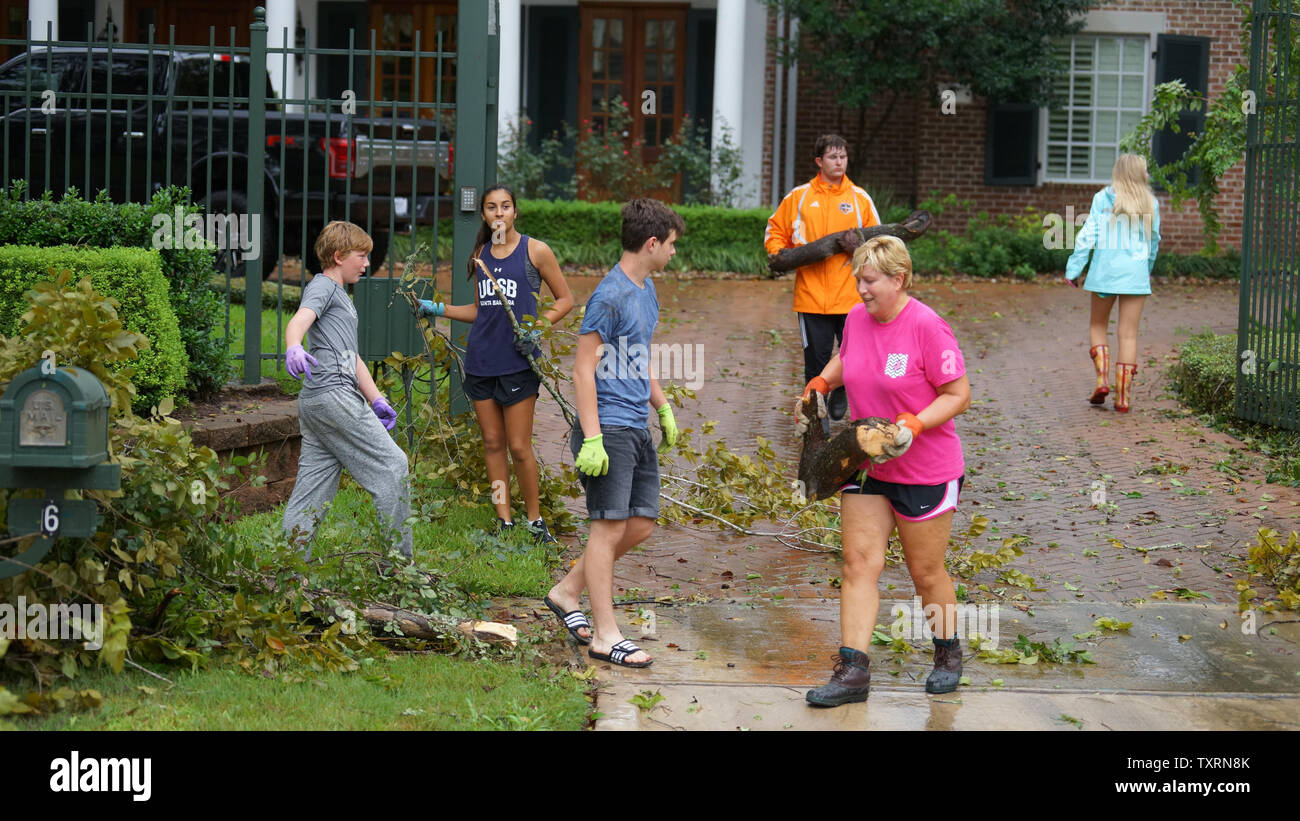 Residents remove debris after a tornado in the Sienna Plantation ...