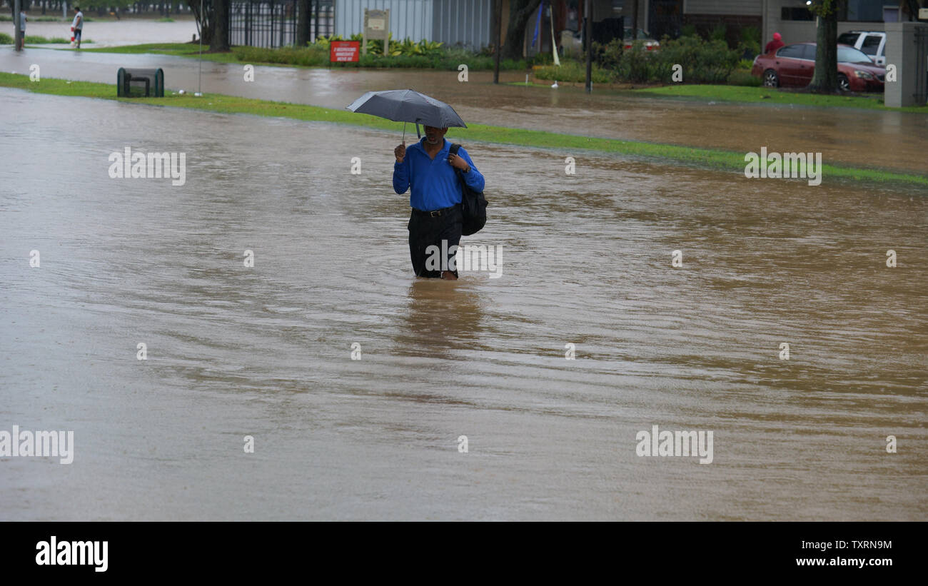 A residents makes his way through rising water as Hurricane Harvey was ...